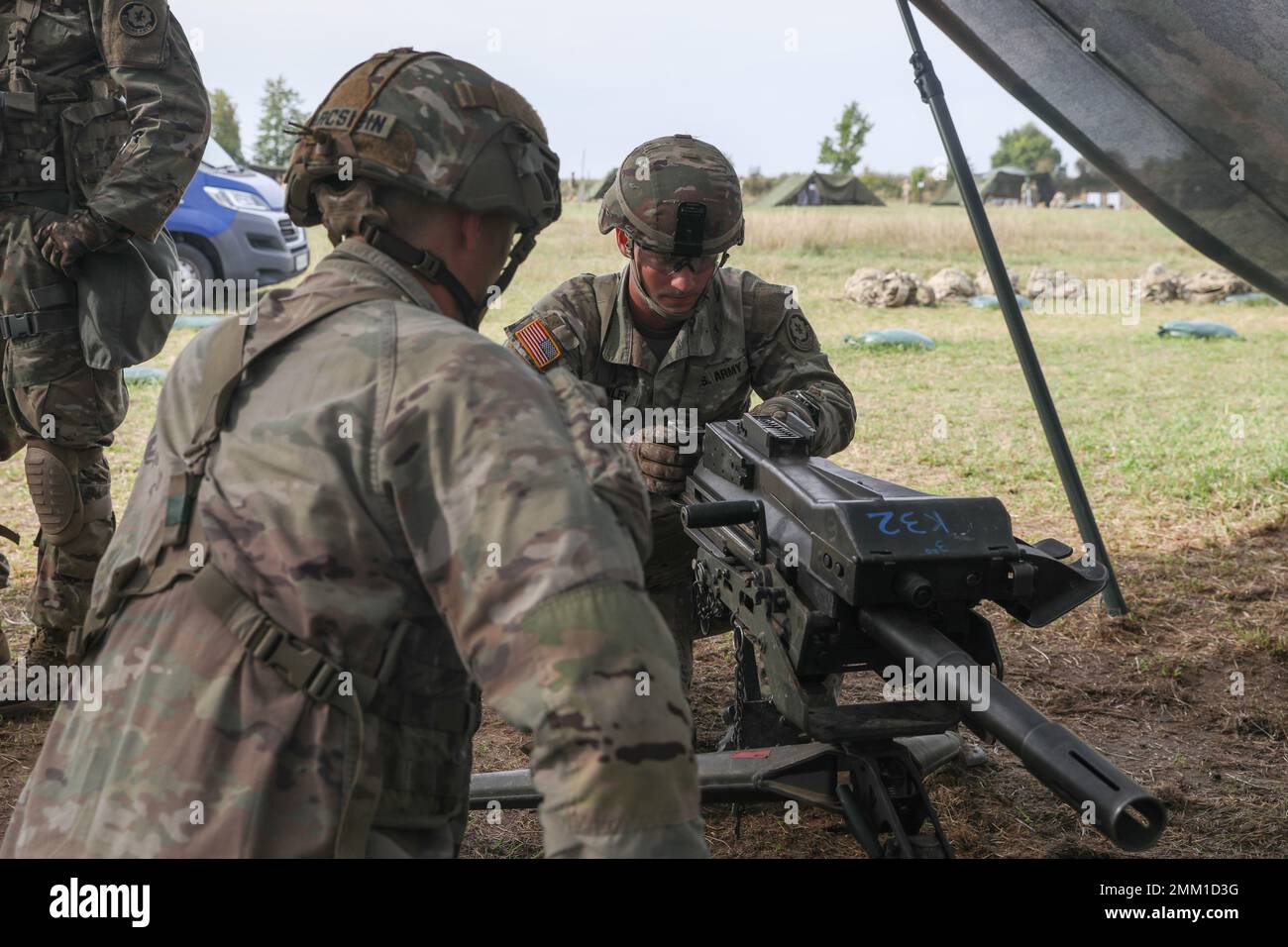 A U.S. Soldier performs weapon maintenance on a MK19 Grenade Machine ...