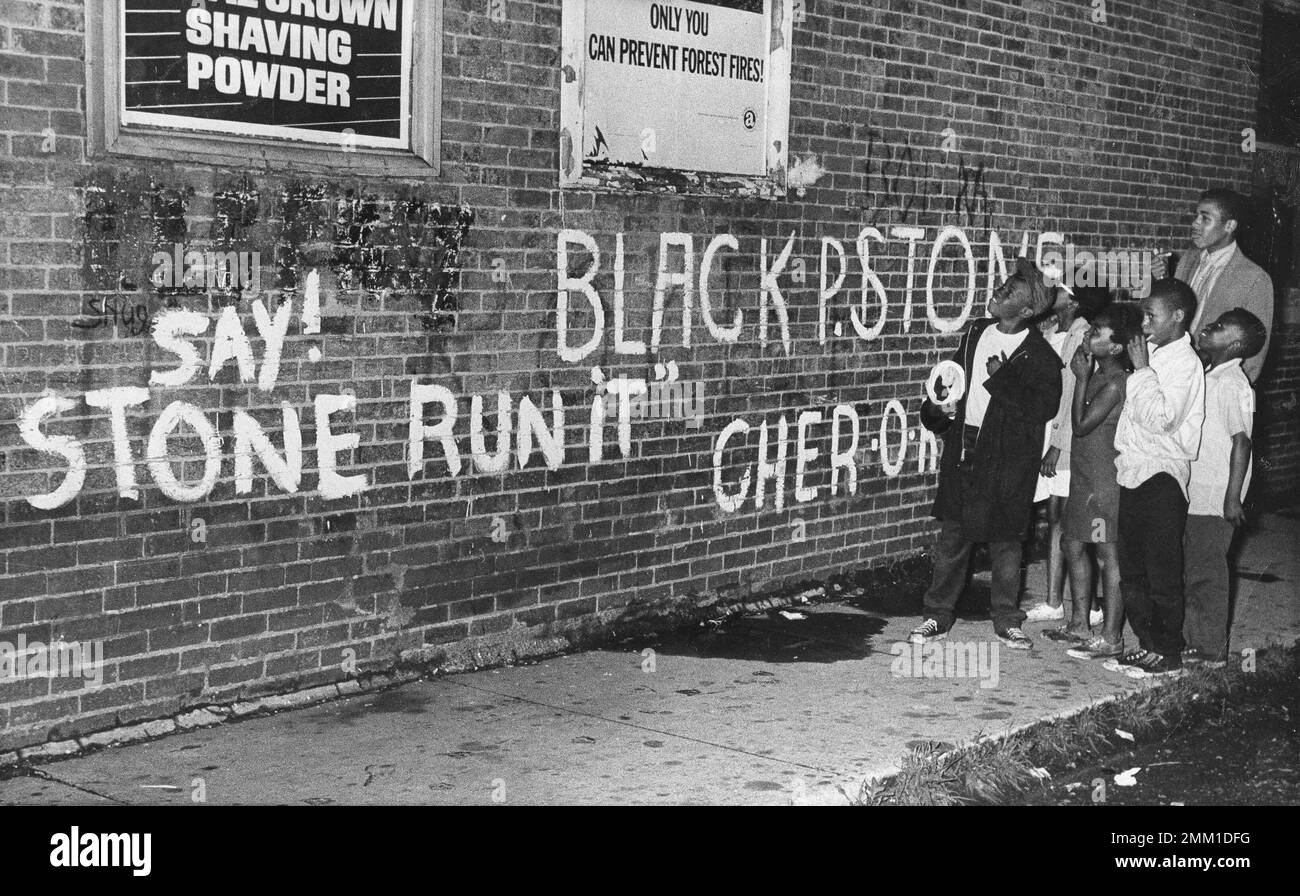 Youngsters stand next to a building on Chicago's South Side that bears ...