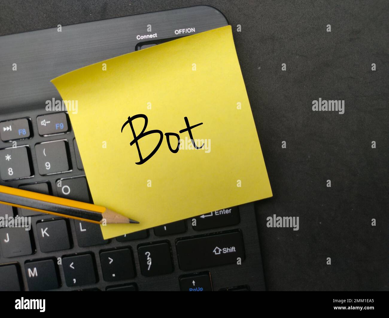 Black keyboard and pencil with the word BOT on black background Stock ...