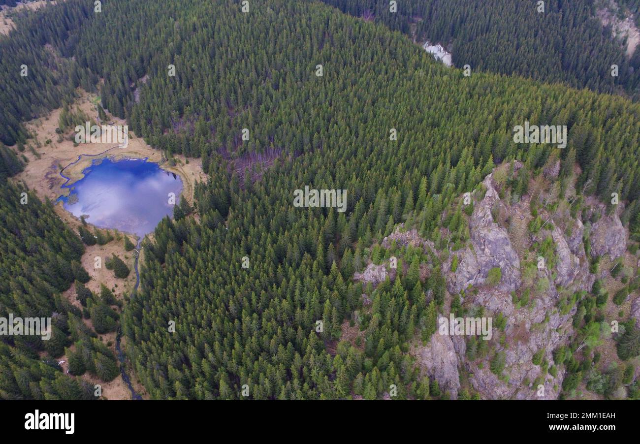 Aerial drone panorama of Iezerul Latoritei glacier lake and the spring ...