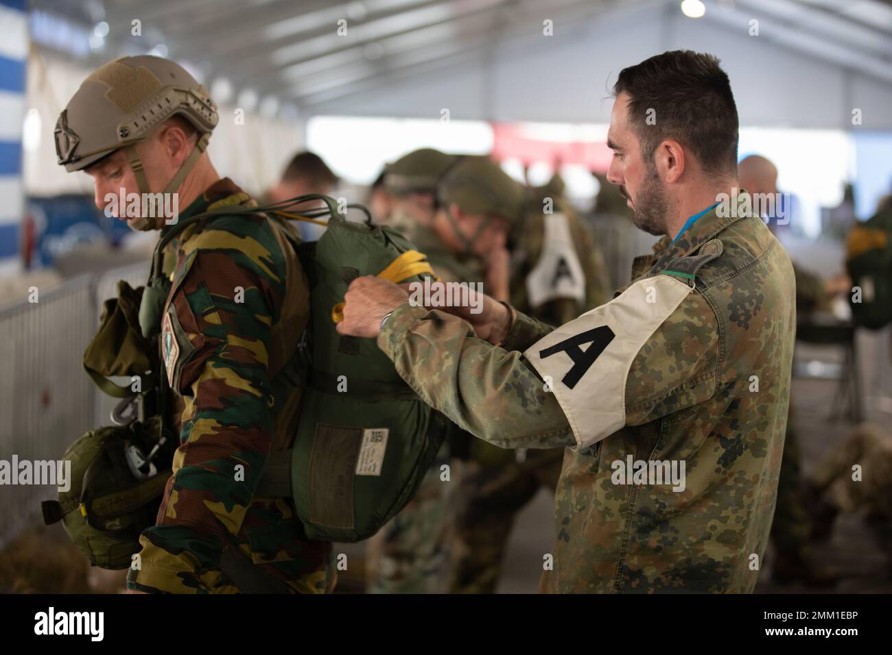 A German Jumpmaster conducts a Jumpmaster Personel Inspection (JMPI) on ...