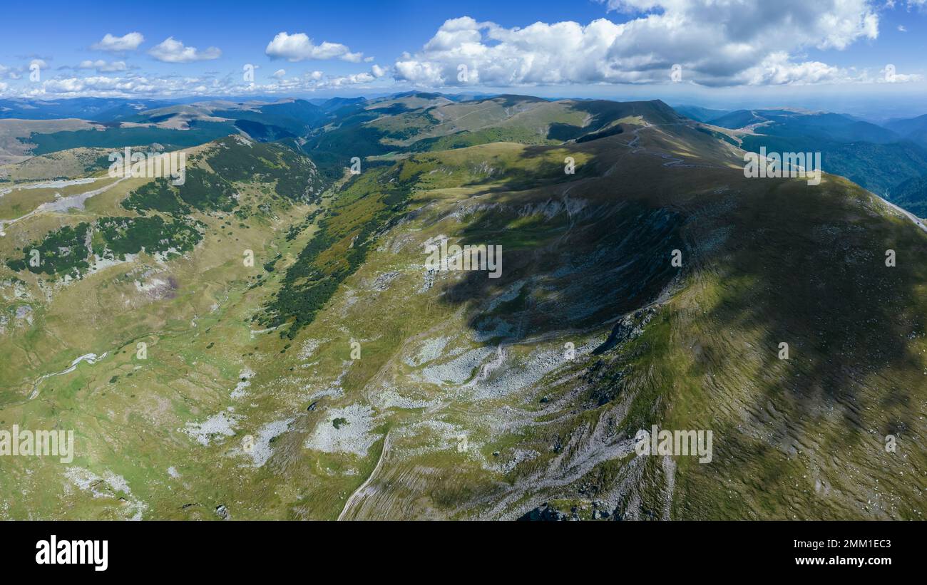 Aerial drone panorama above Transalpina road winding along sharp ...