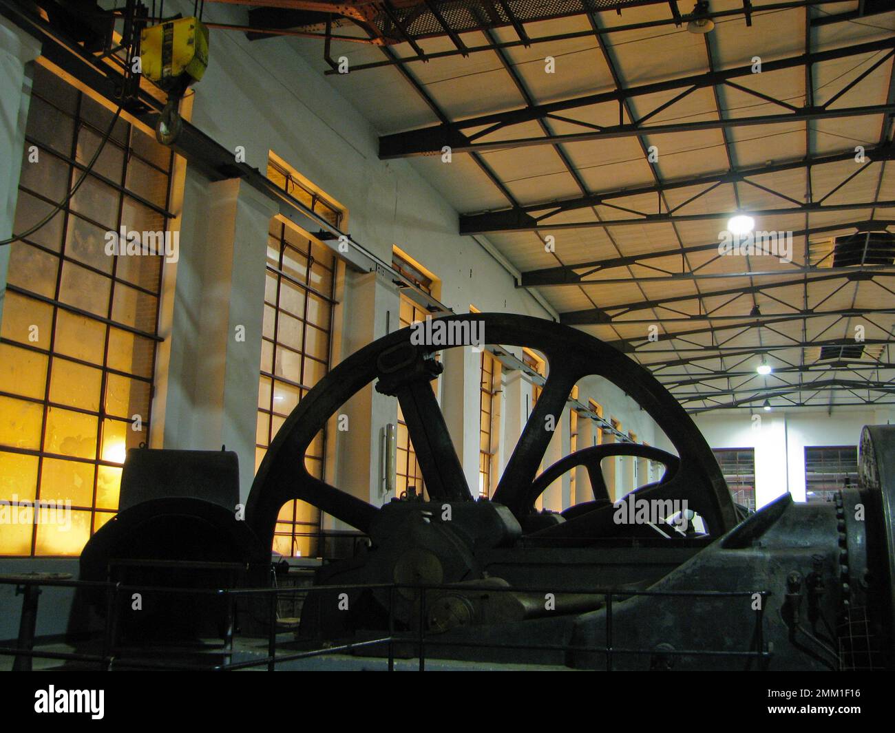 An old machine hall with large flywheels for power generation Stock ...
