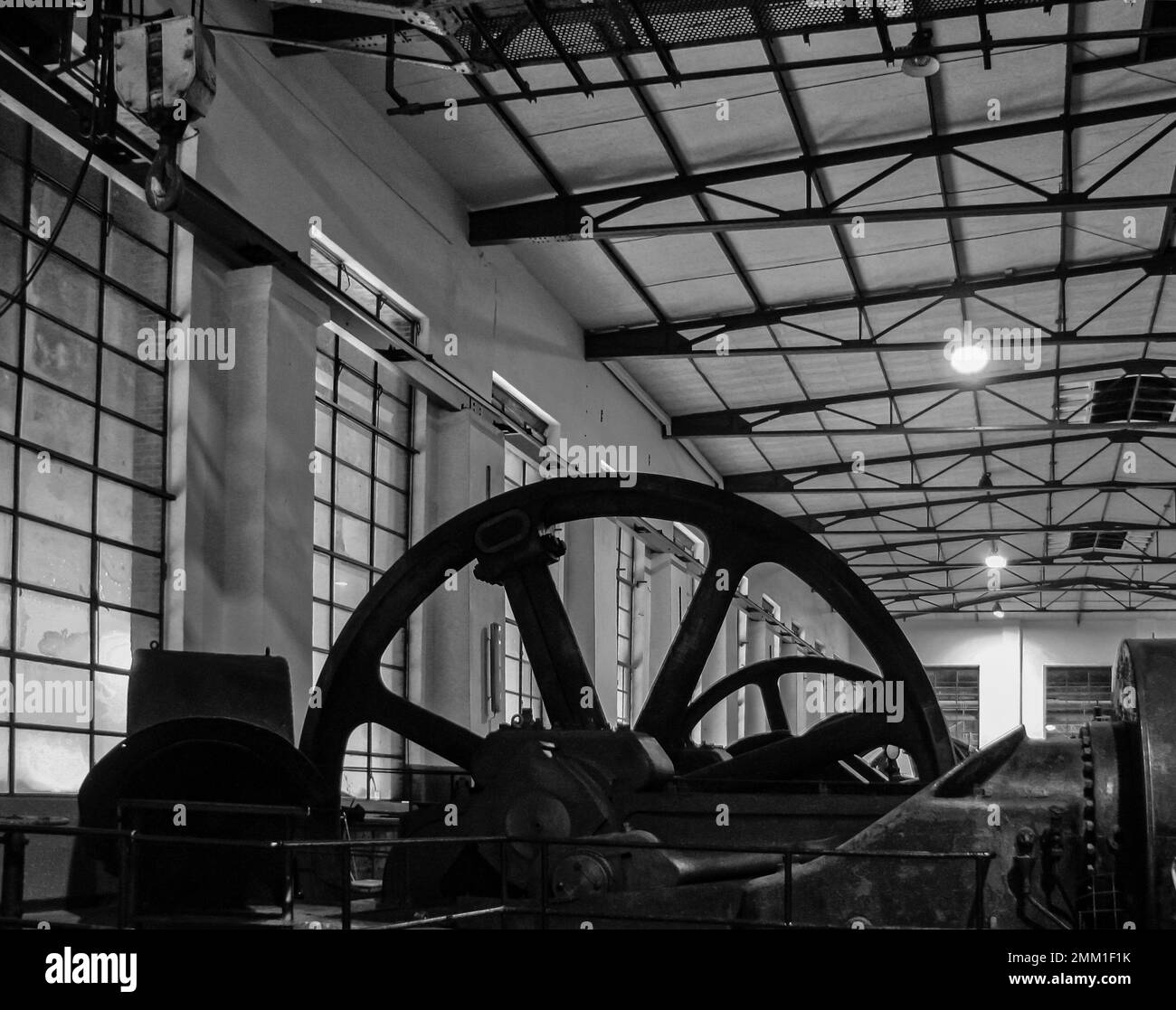 An old machine hall with large flywheels for power generation Stock ...