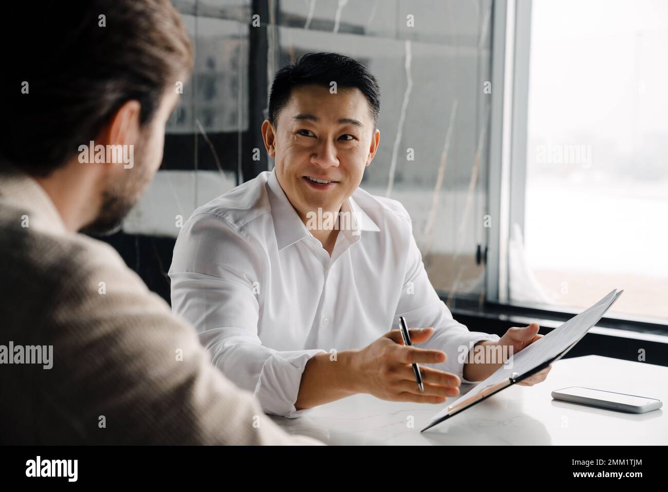 Asian businessman explaining project hi-res stock photography and ...