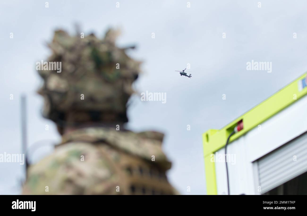 A Czech joint terminal attack controller (JTAC) watches a U.S. Army AH ...