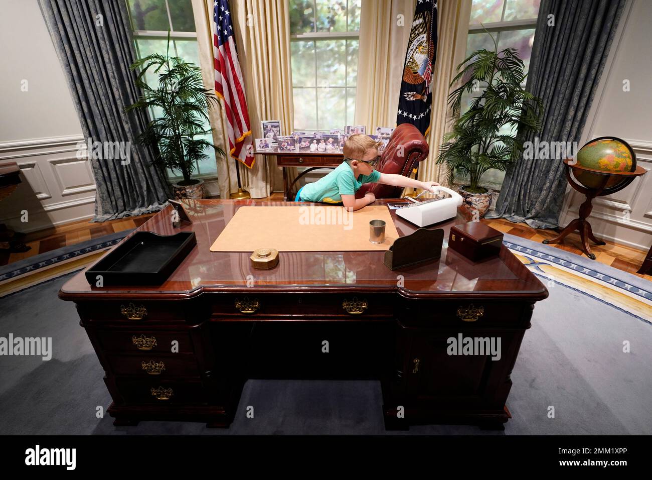 Kalob Duke, 6, of College Station, Texas, sits behind the desk in a ...
