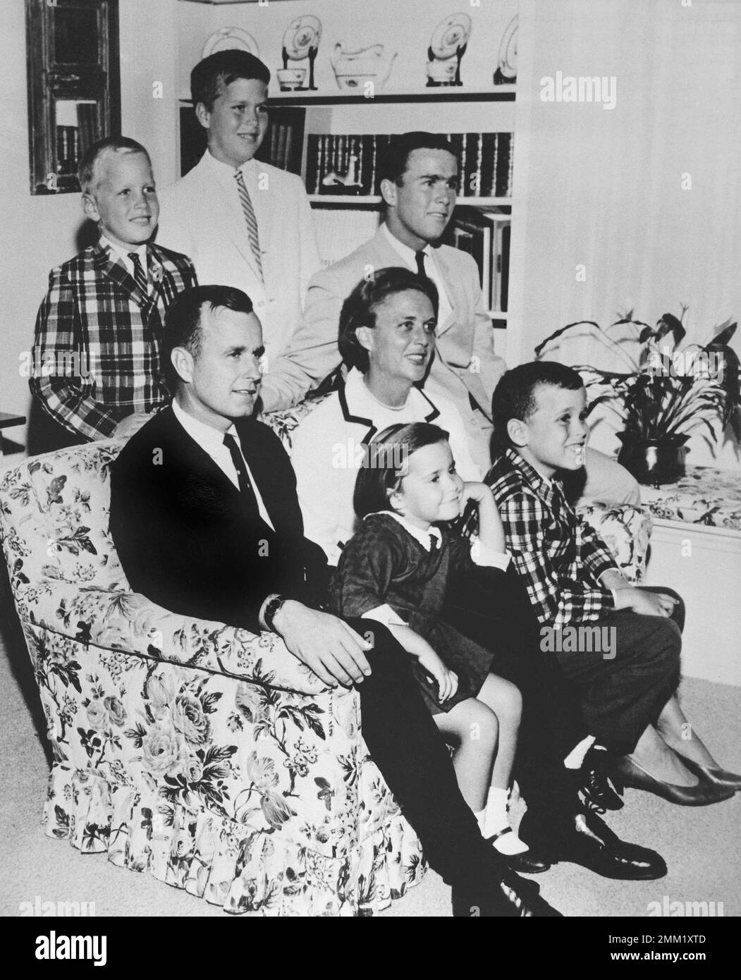 FILE - In this 1964 file photo, George H.W. Bush sits on couch with his ...