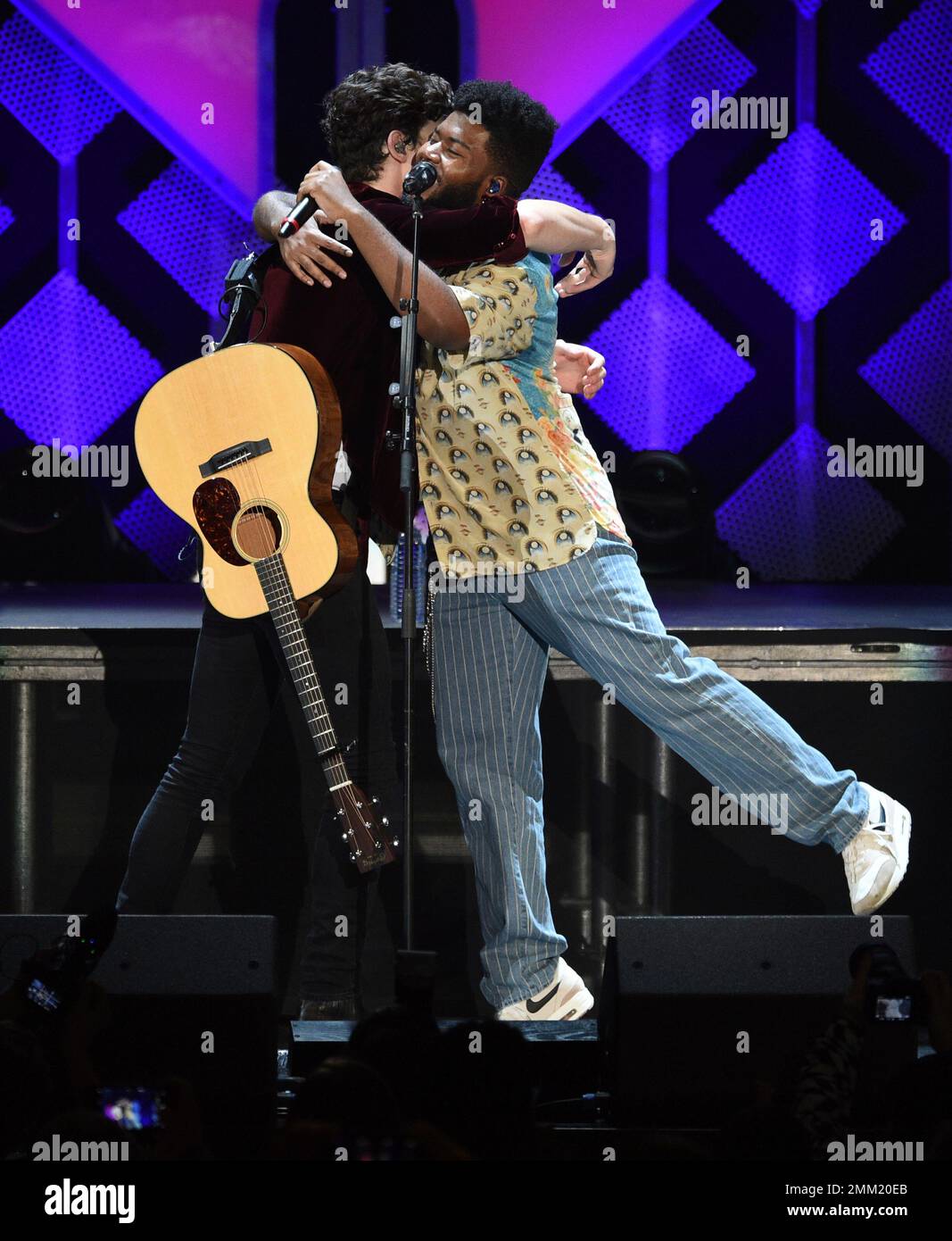 Shawn Mendes, left, and Khalid hug after performing at Jingle Ball on ...