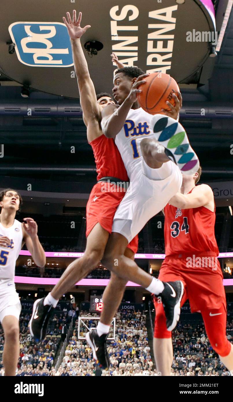 Pittsburgh's Xavier Johnson (1) tries to shoot as Duquesne's Sincere ...