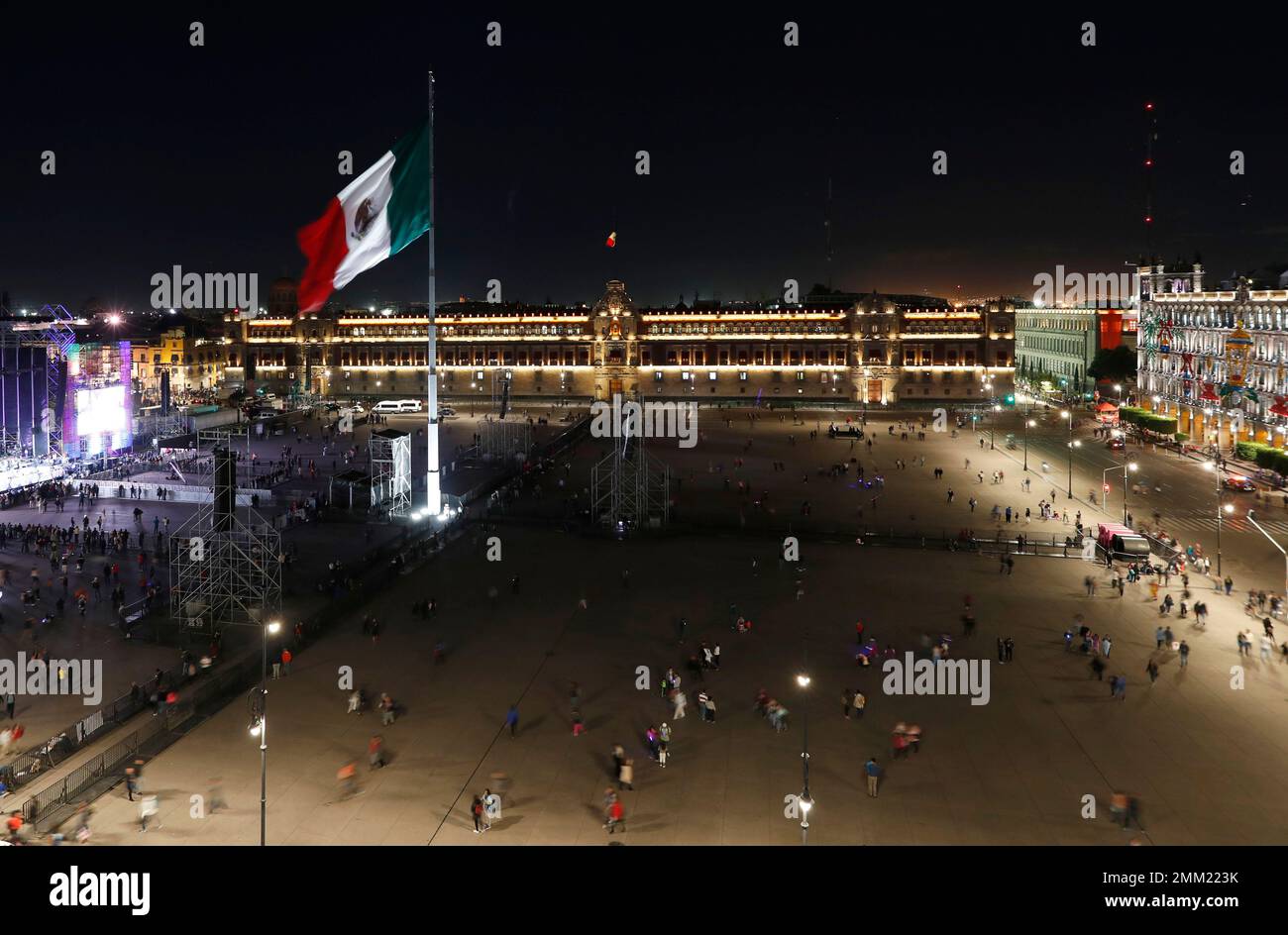 Residents walk in Mexico City's main plaza, The Zocalo, as workers ...