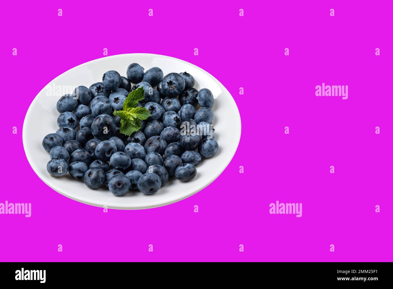 Blueberry in plate on isolated background Stock Photo - Alamy