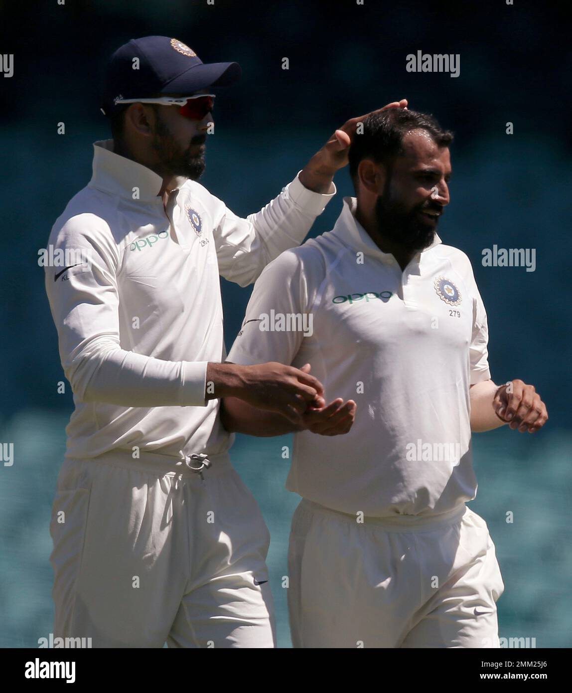 India's Mohammed Shami, right, is patted on the head by teammate K.L ...