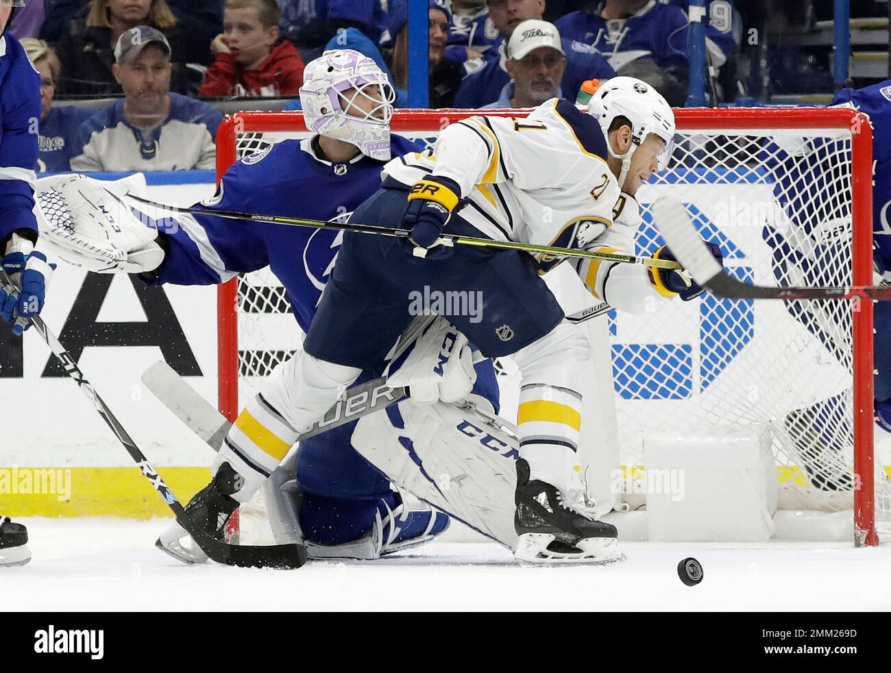 Buffalo Sabres right wing Kyle Okposo (21) runs into Tampa Bay ...