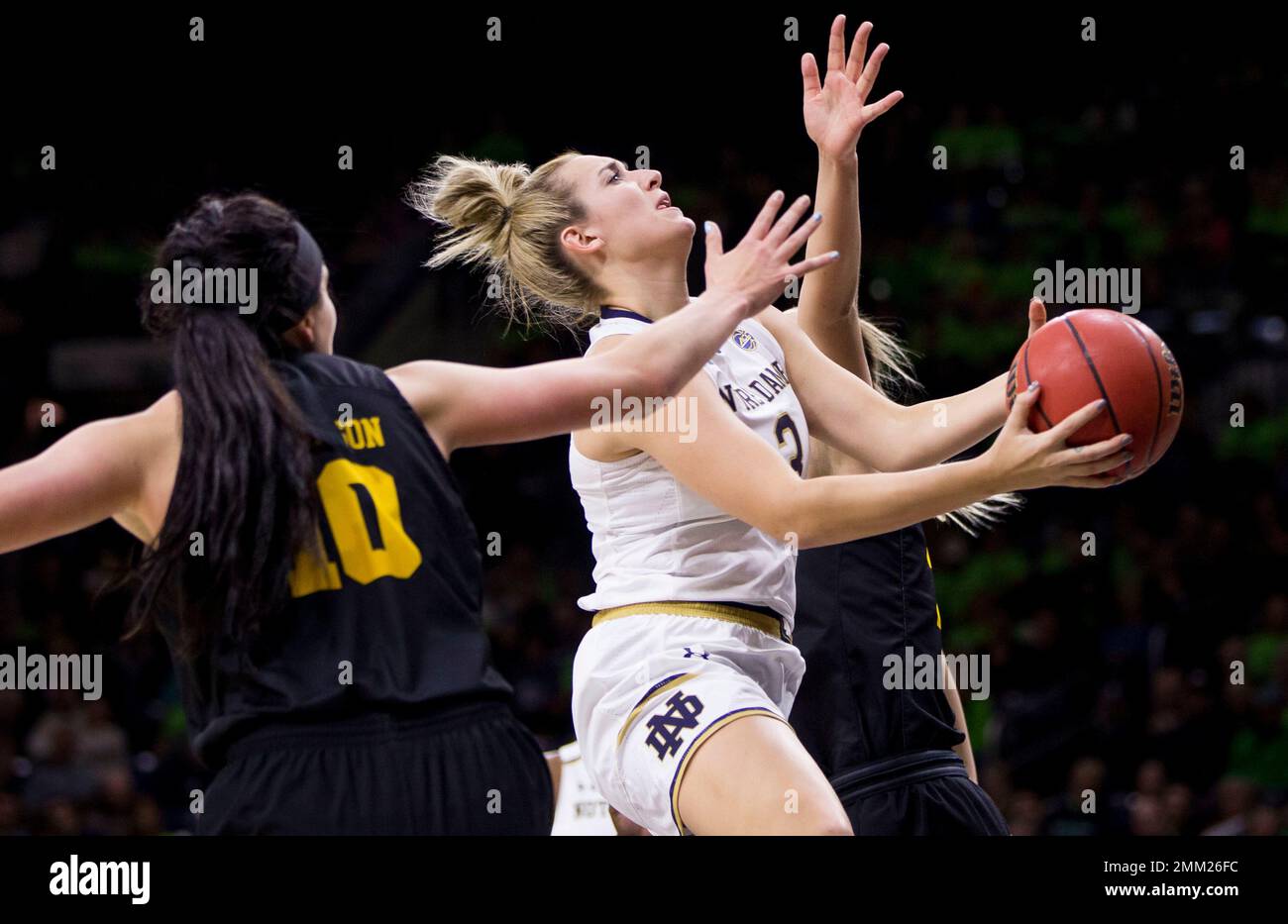 Notre Dame's Marina Mabrey (3) drives between Iowa's Megan Gustafson ...