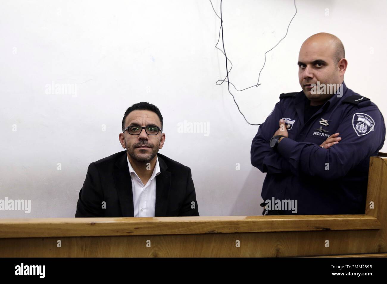 Israeli policeman stand by a Palestinian governor of Jerusalem Adnan ...