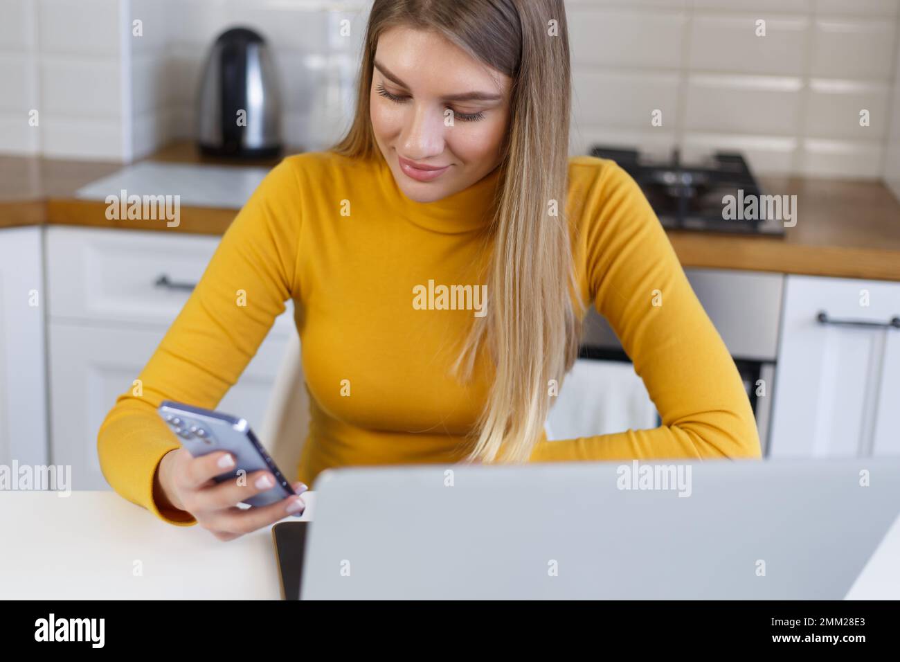 Beautiful blonde girl browsing mobile app on smart phone. Young ...