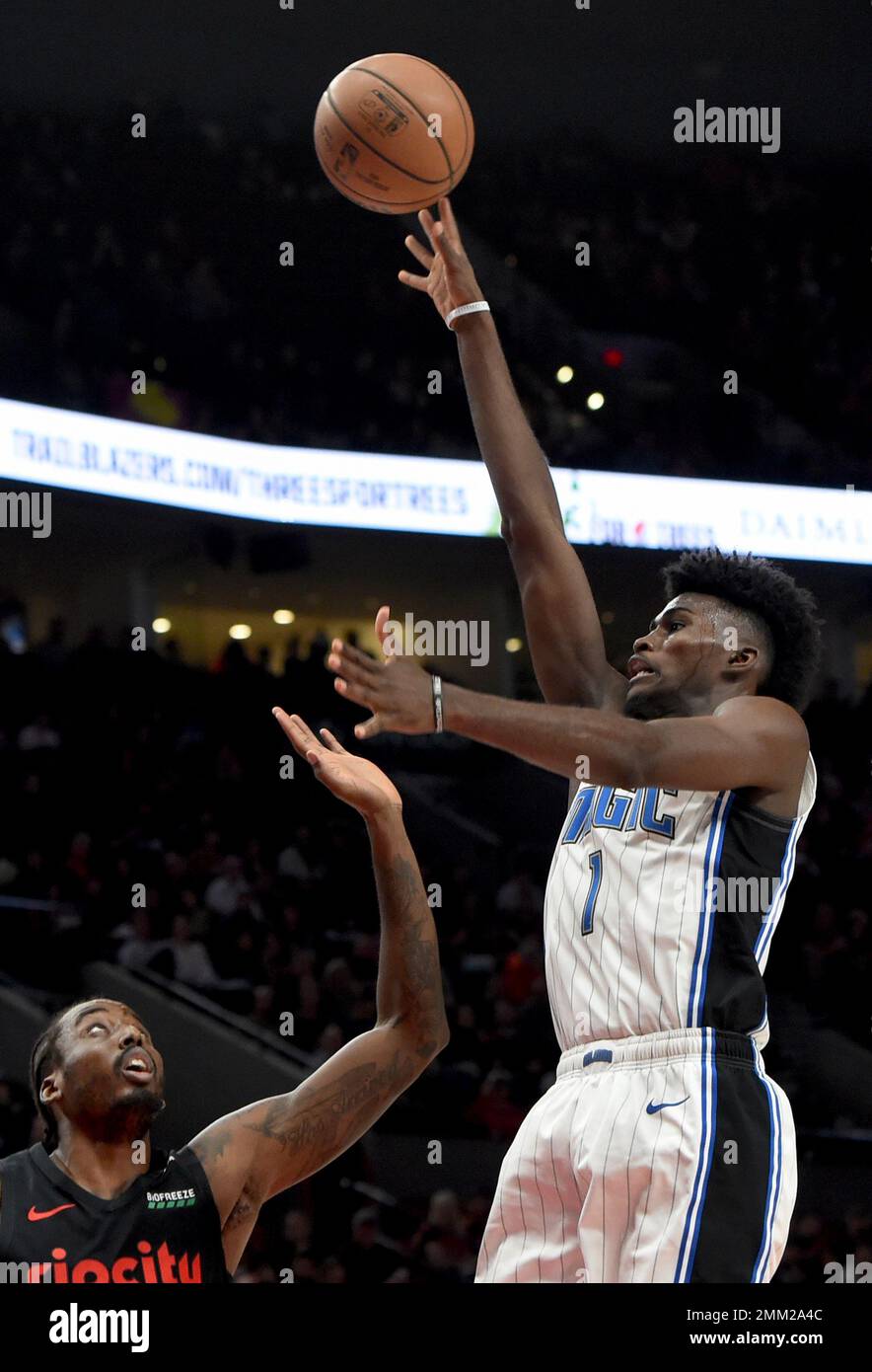 Orlando Magic forward Jonathan Isaac, right, shoots over Portland Trail ...