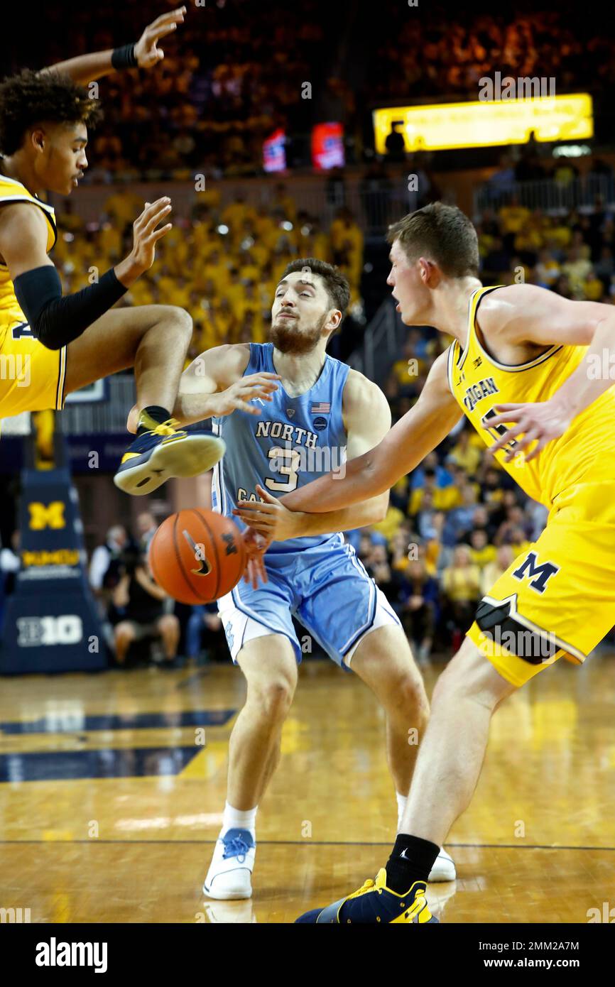 North Carolina guard Andrew Platek (3) loses the ball as Michigan guard ...