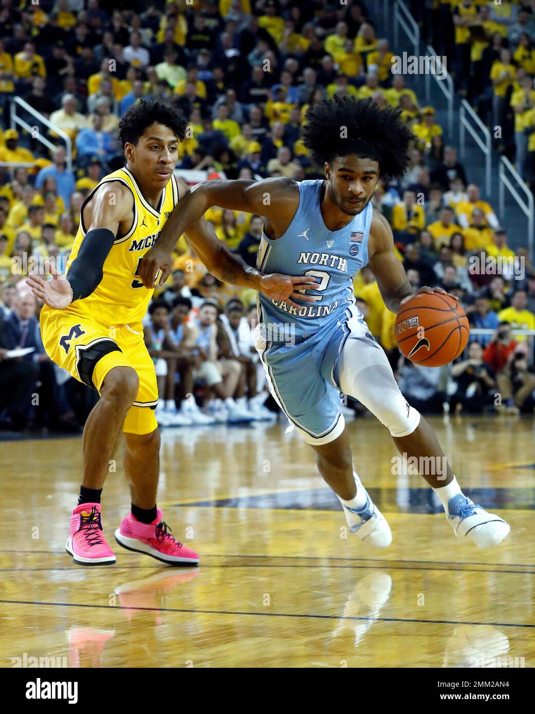 North Carolina guard Coby White (2) drives on Michigan guard Eli Brooks ...