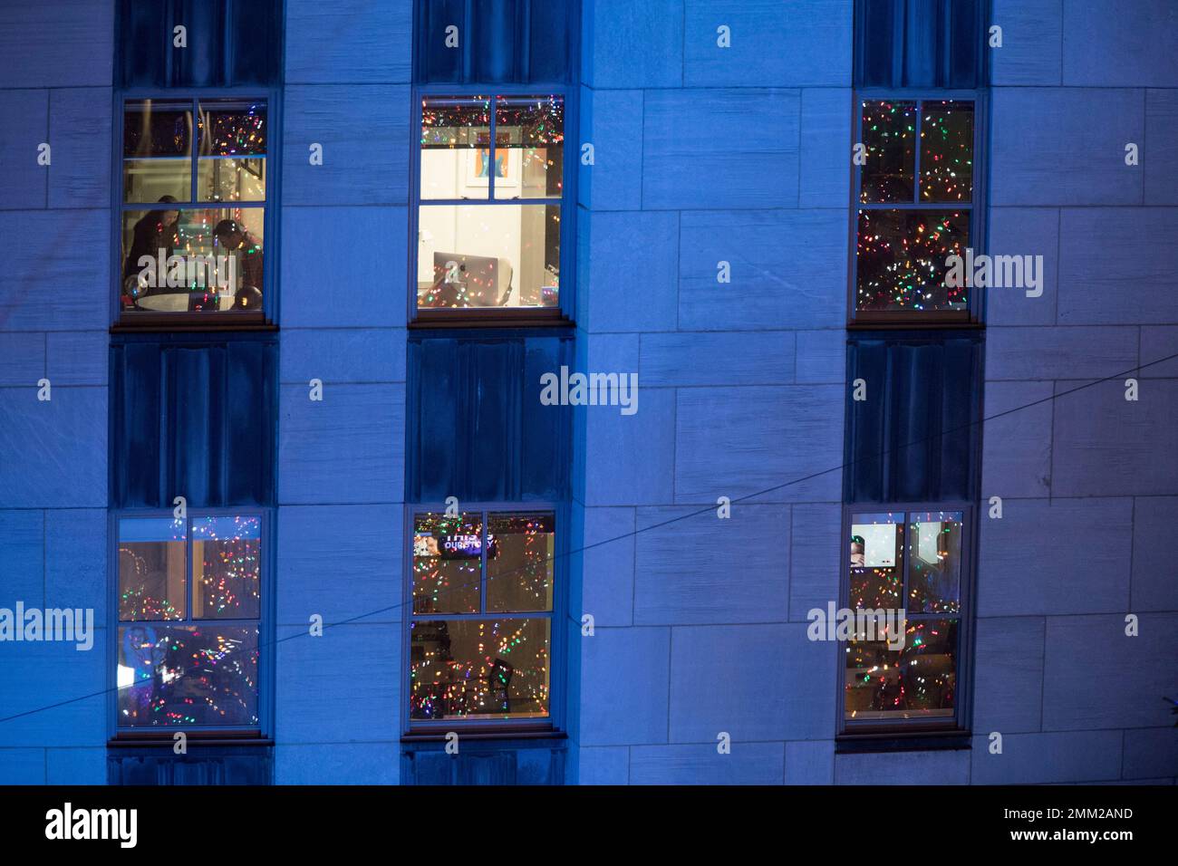 People work in their office after the Rockefeller Center Christmas tree ...