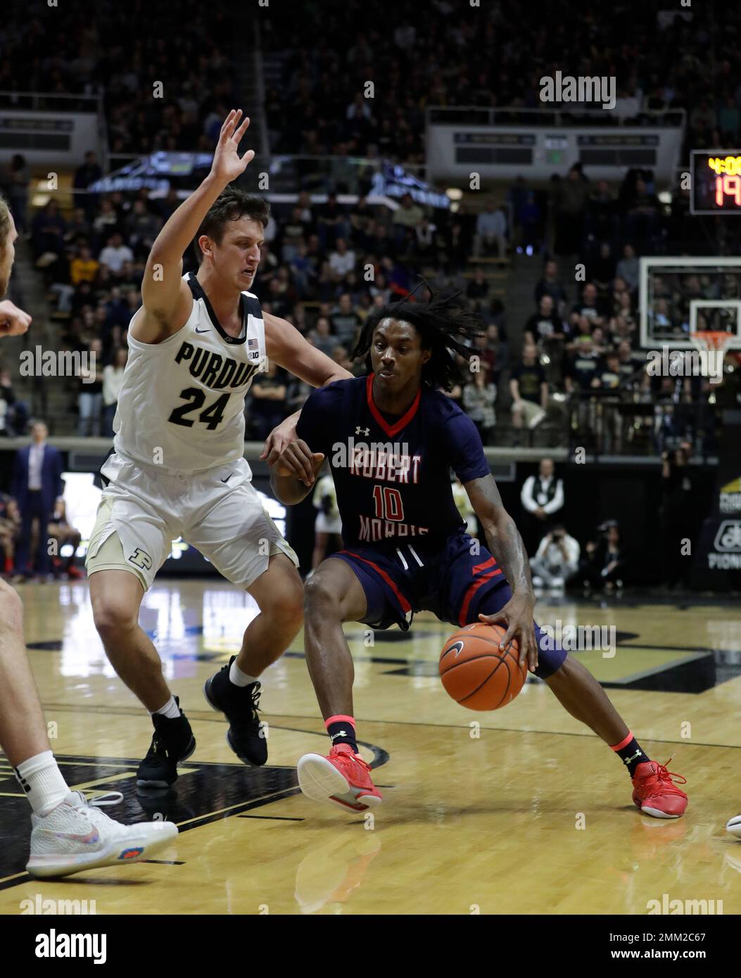 Robert Morris's Koby Thomas (10) is defended by Purdue's Grady Eifert ...