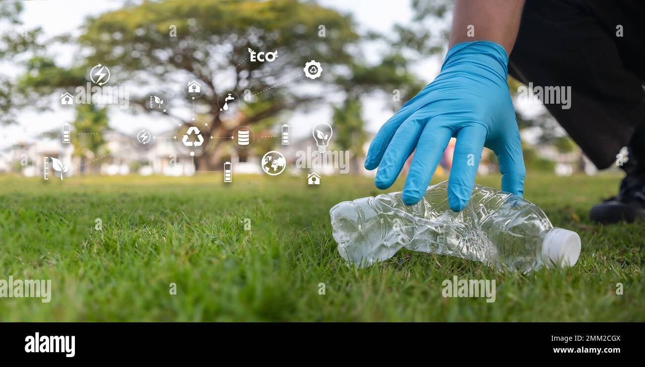 Volunteer man collecting trash and reusing plastic cleanup to recycle ...
