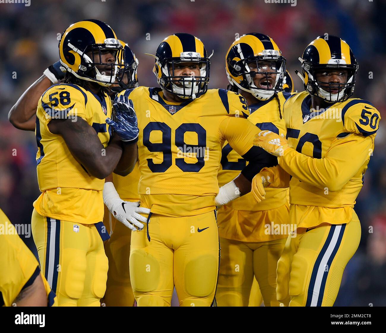 Los Angeles Rams defensive end Aaron Donald (99) huddles with the ...
