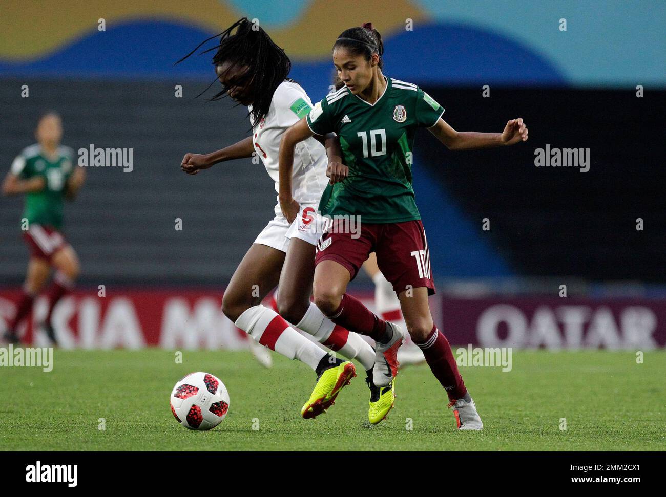 Alison Gonzalez of Mexico, right, fights for the ball with Maya Antoine ...