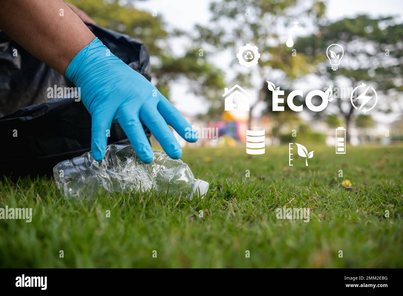 Volunteer man collecting trash and reusing plastic cleanup to recycle ...