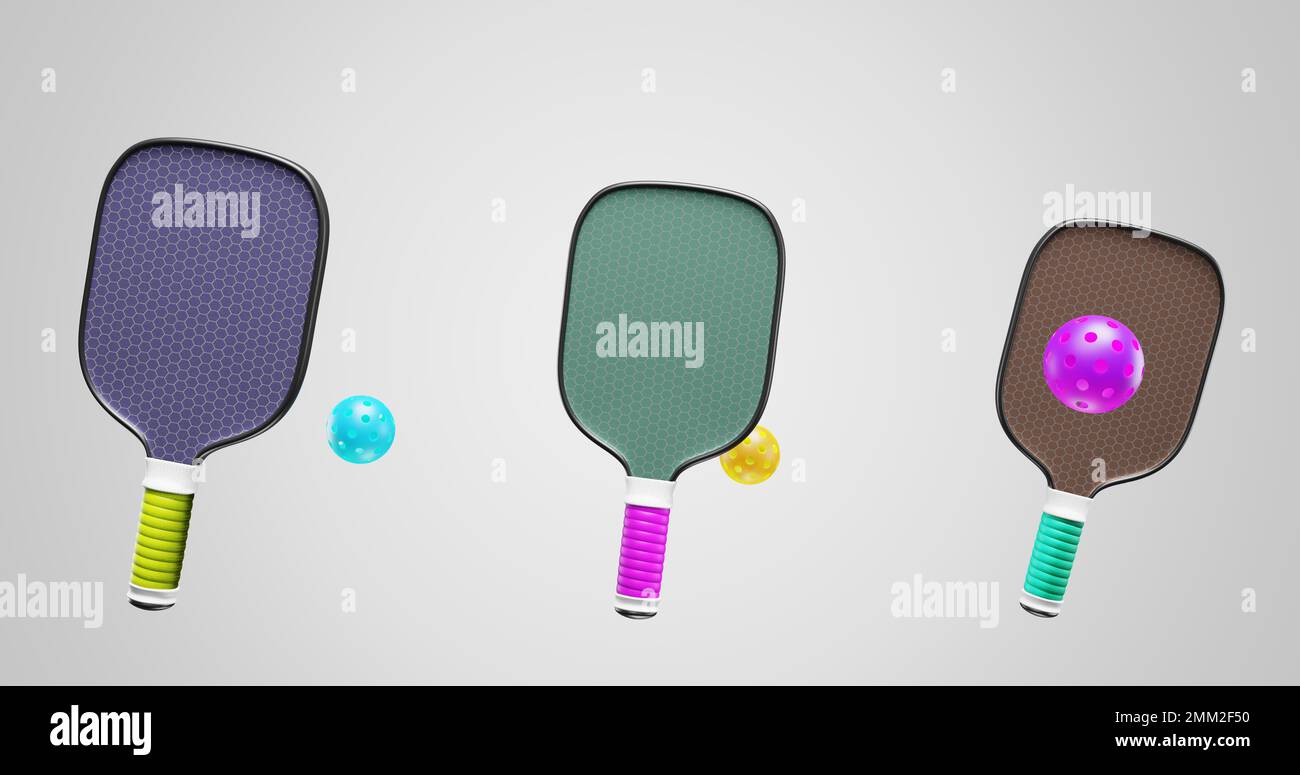 Pickle ball three paddle rackets with plastic balls on a gray ...