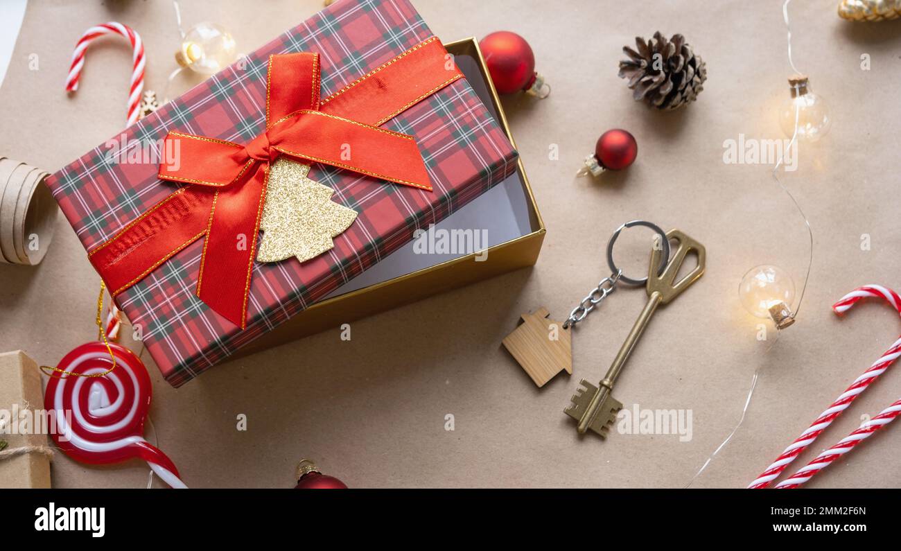 Key to house with keychain on cozy home in gift box with Christmas ...