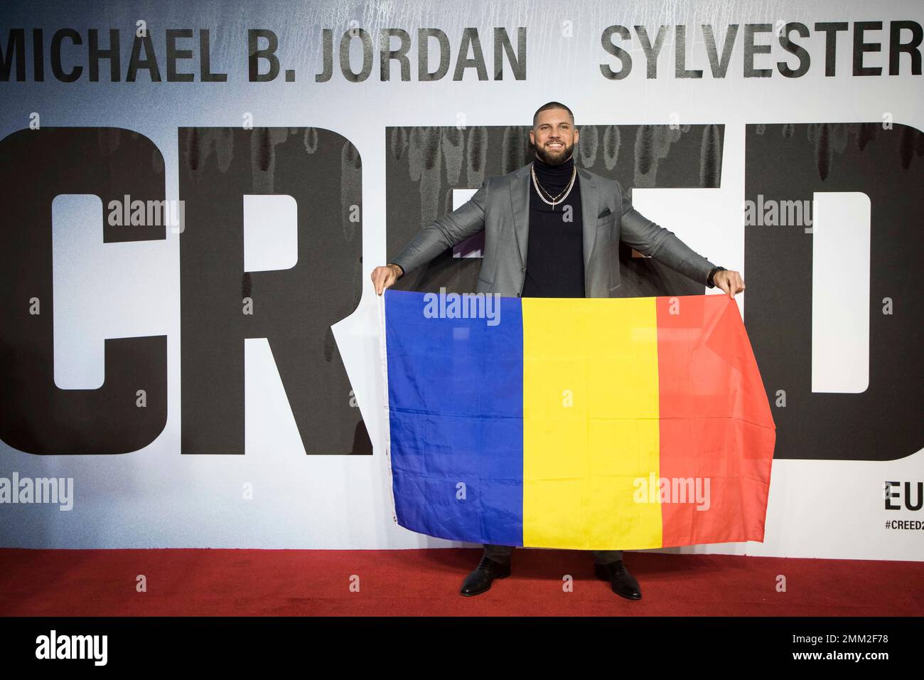 Actor Florian Munteanu poses for photographers with the flag of Romania ...