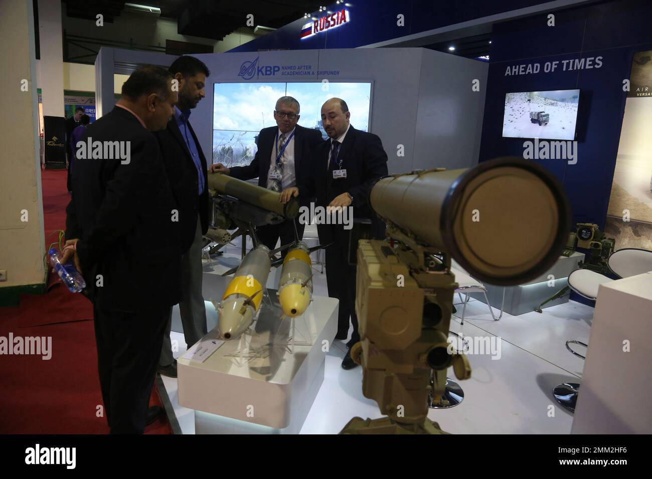 People visit a stall at a defense exhibition in Karachi, Pakistan ...
