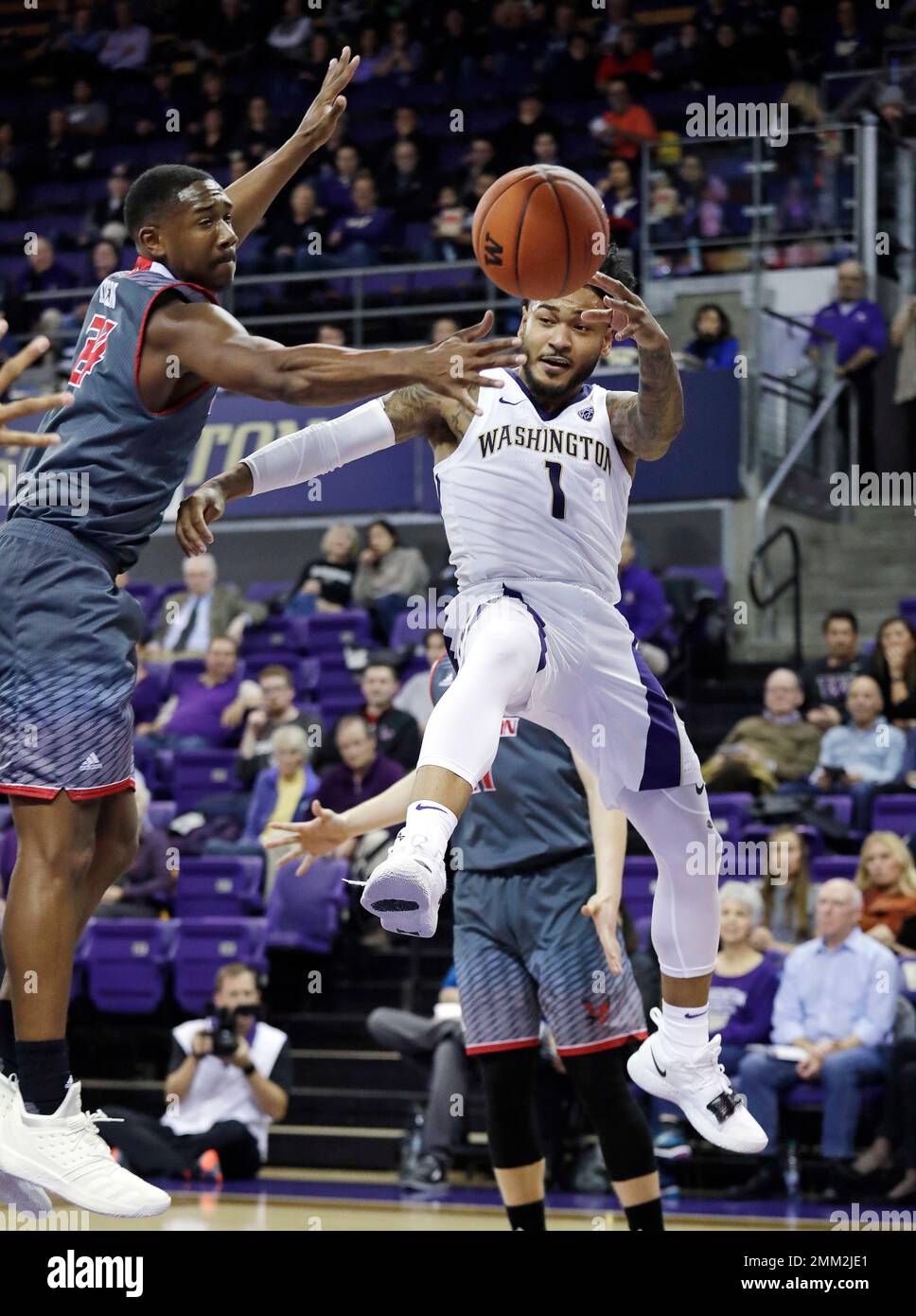 Washington's David Crisp (1) passes under the basket as Eastern ...