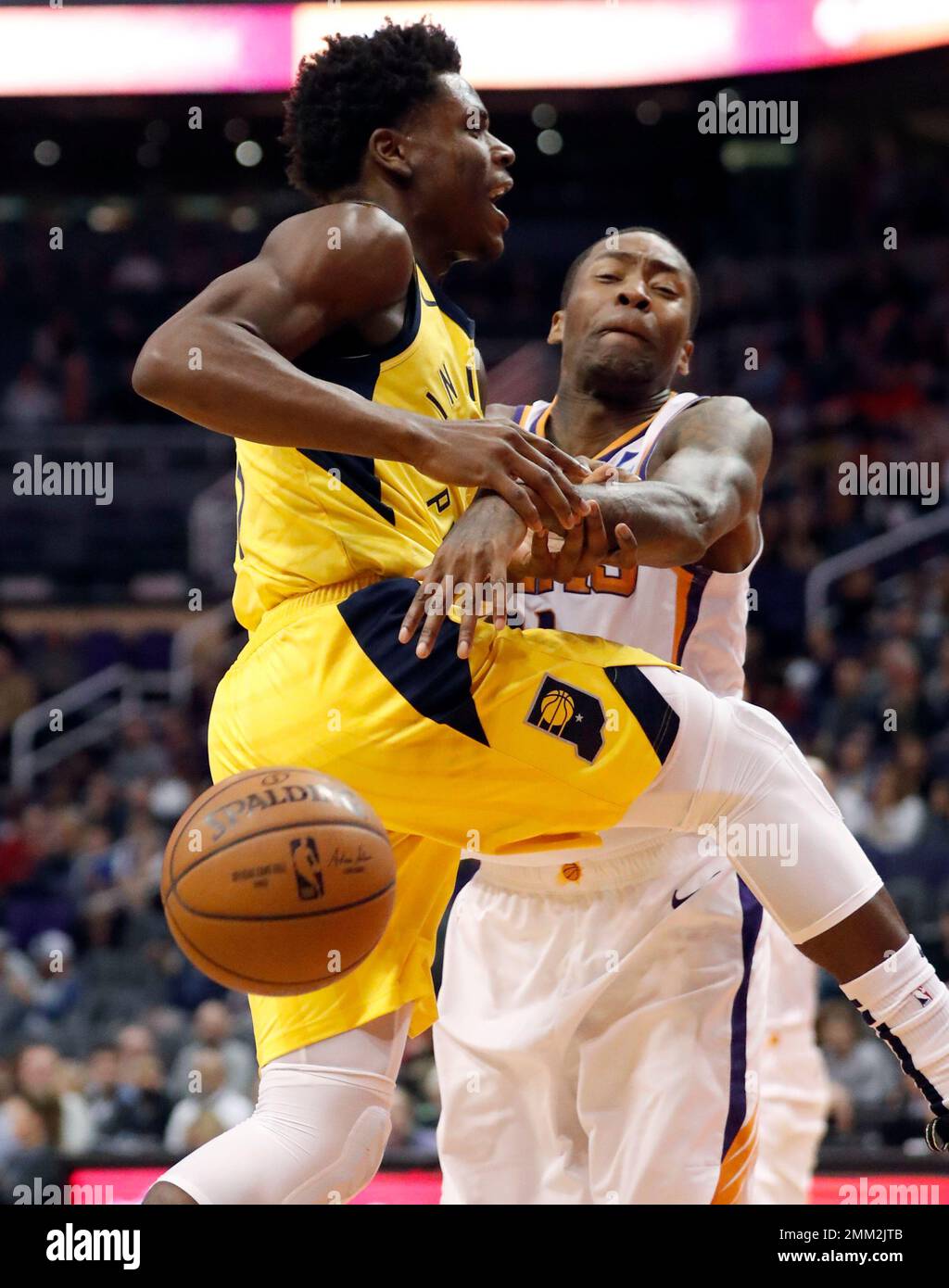 Indiana Pacers guard Aaron Holiday is fouled by Phoenix Suns guard ...