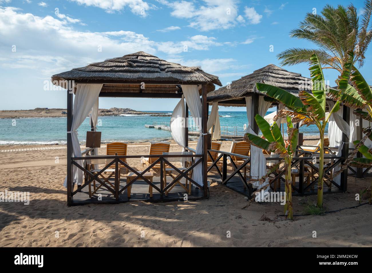 Vacation resorts on Cyprus near Paprhos with green grass, beach ...