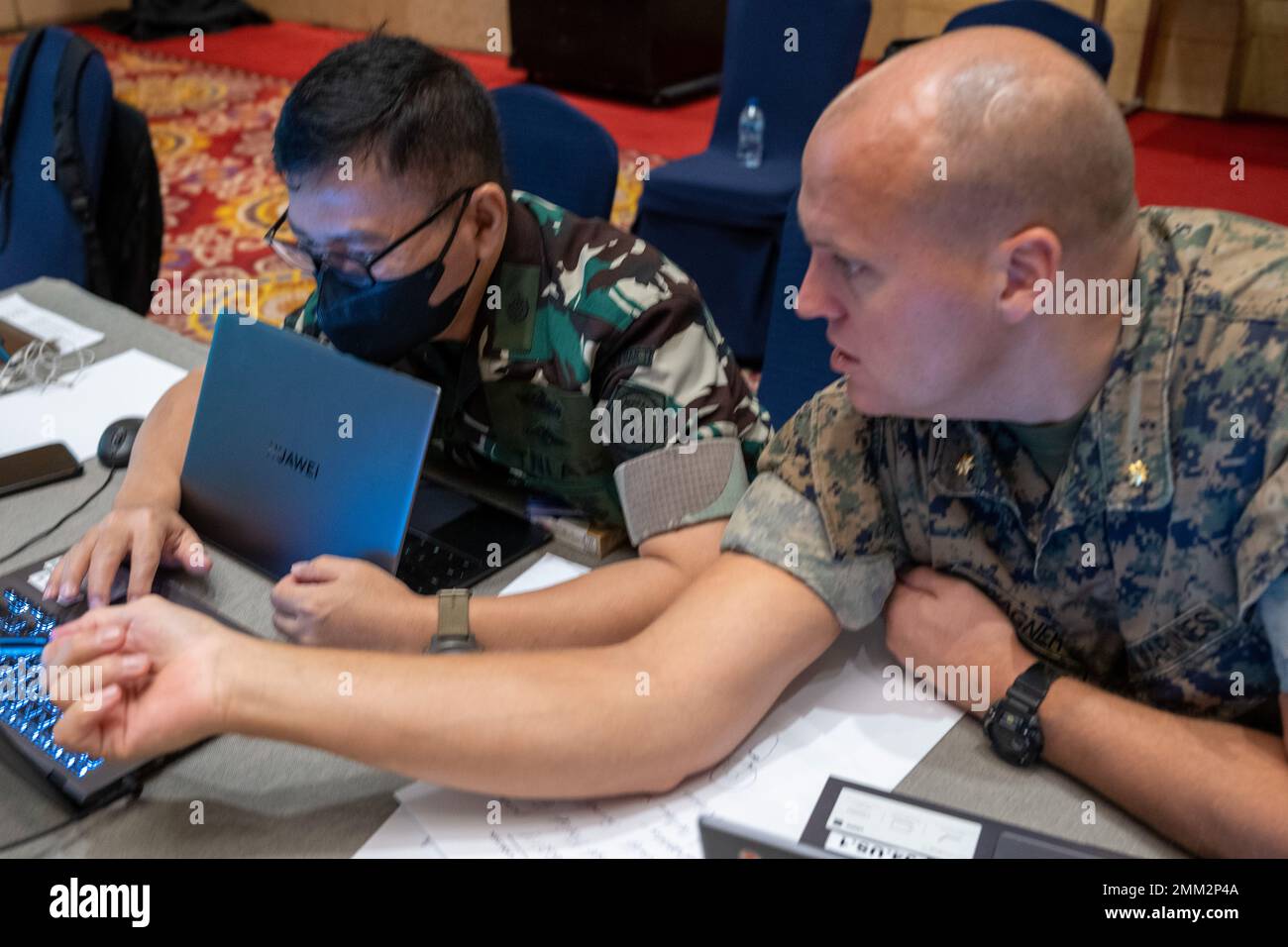 TNI Navy Capt. Laswanto and U.S. Marines Maj. Peter Wagner analyze ...