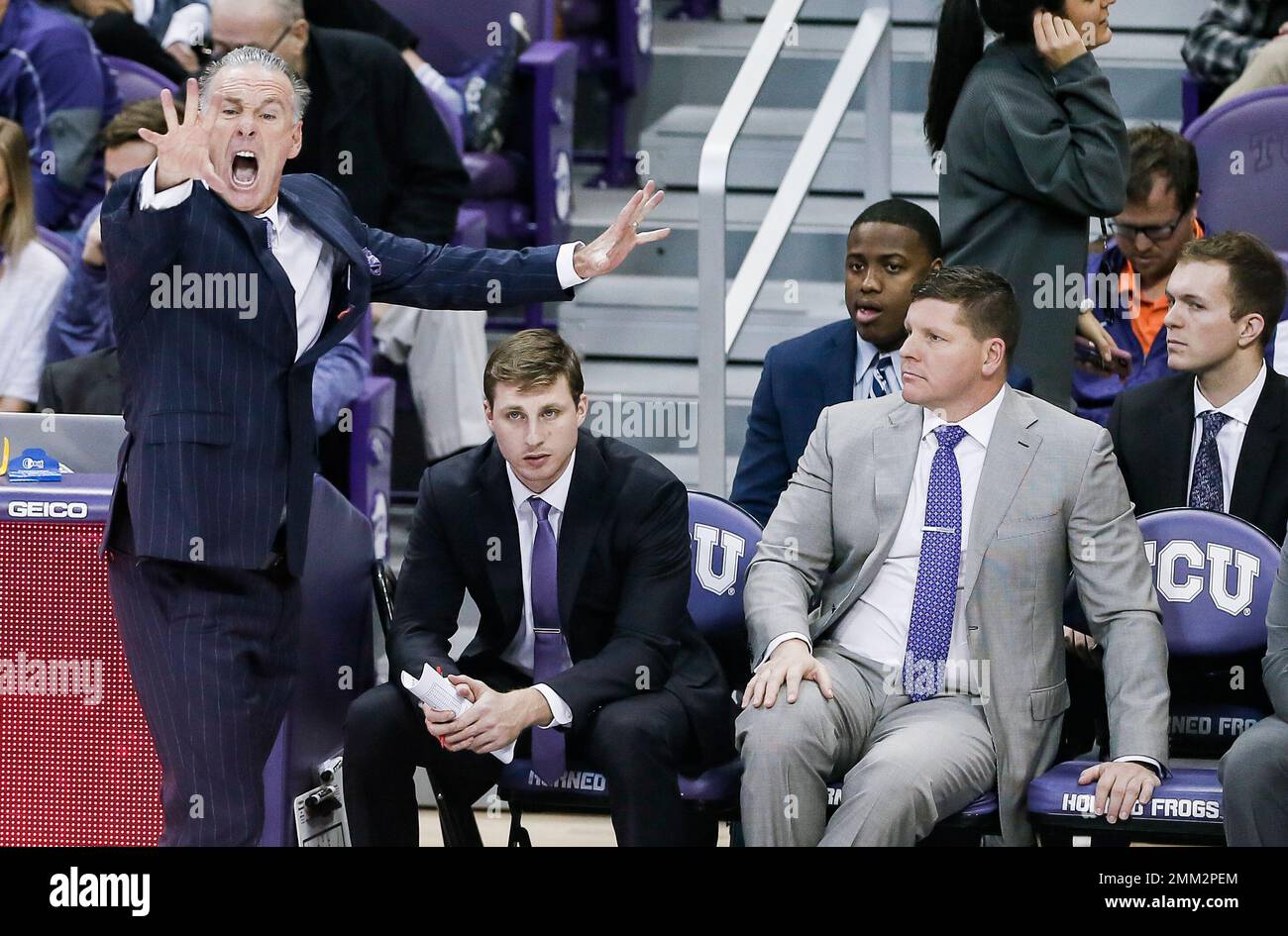 TCU head coach Jamie Dixon, left, shouts instructions to his team ...