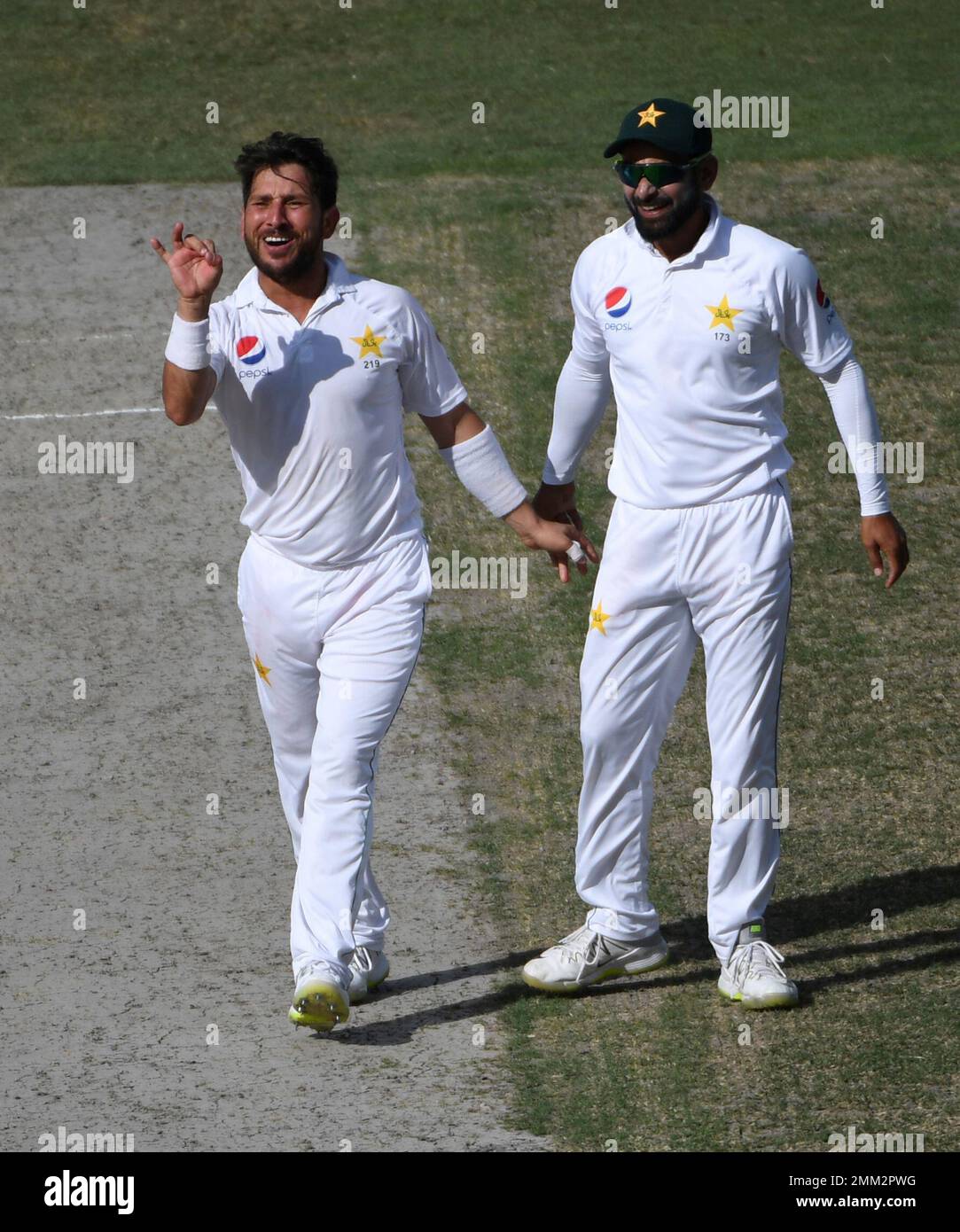 Pakistan's bowler Yasir Shah (L) reacts with Mohammad Hafeez during a ...