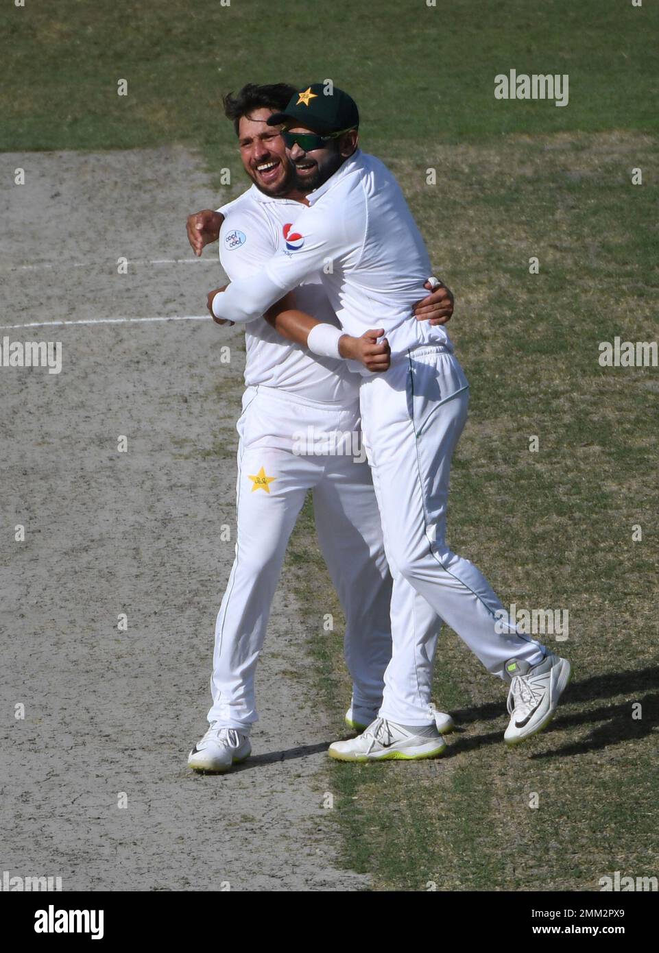 Pakistan's bowler Yasir Shah (L) reacts with Mohammad Hafeez during a ...