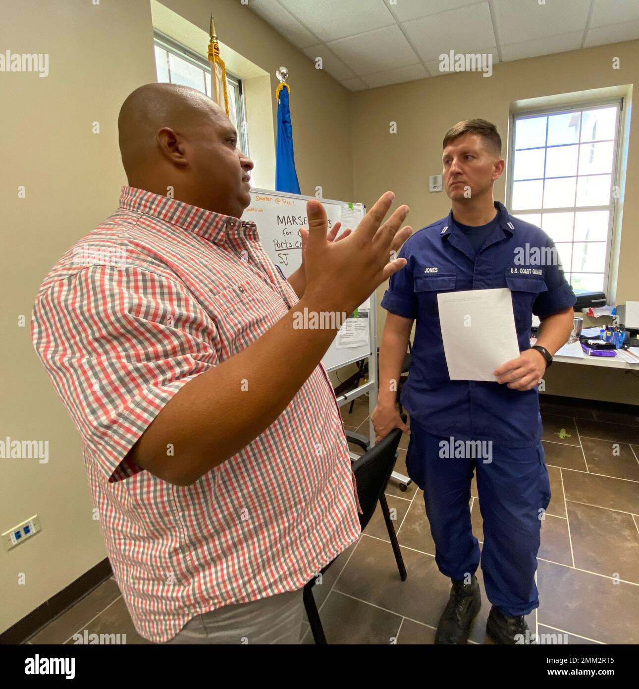 Emilio Mercado (left) speaks to Lt. Joel Jones (right) during the Area ...