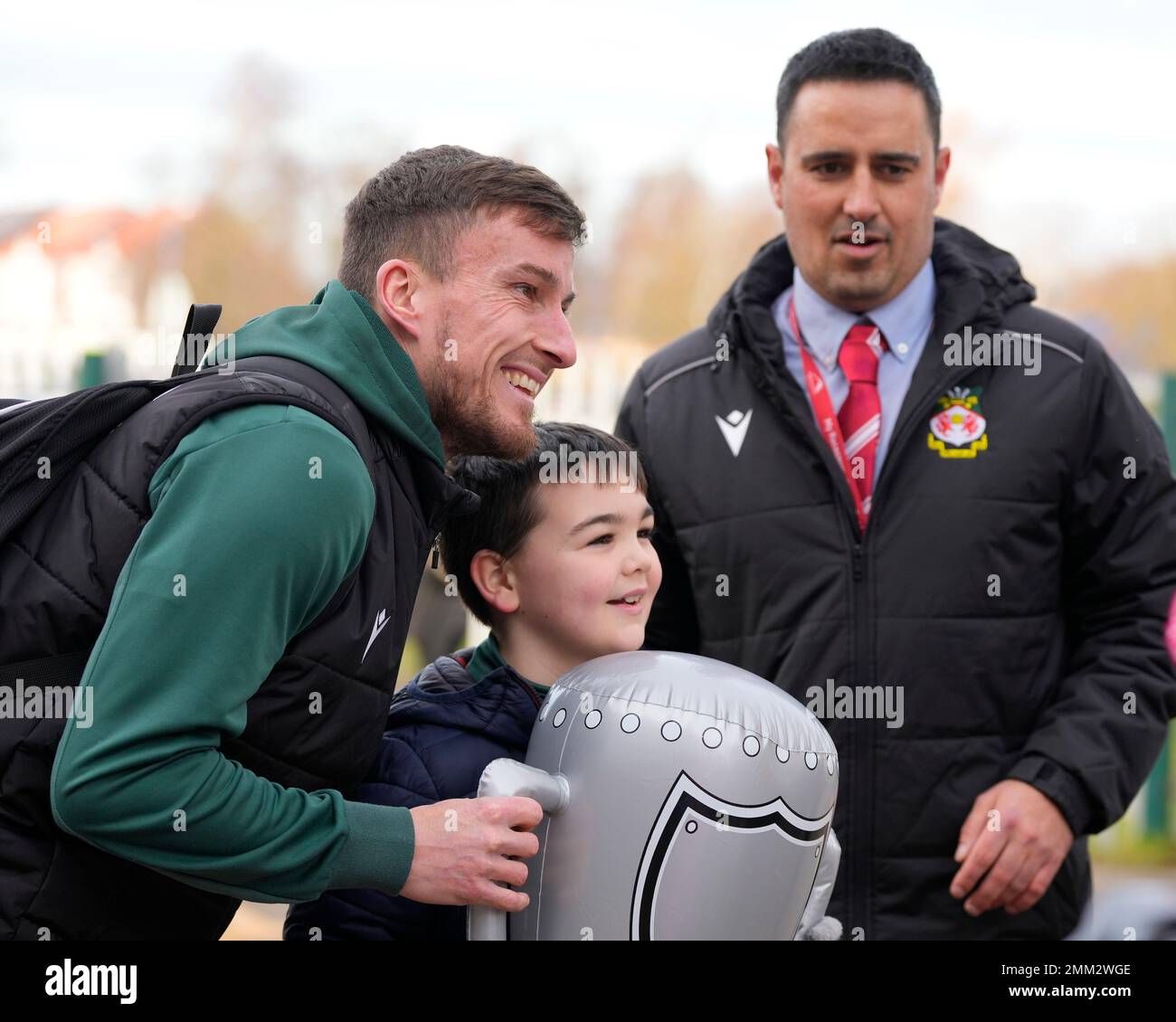 Luke Young #8 of Wrexham poses for a photo with a young fan before the ...