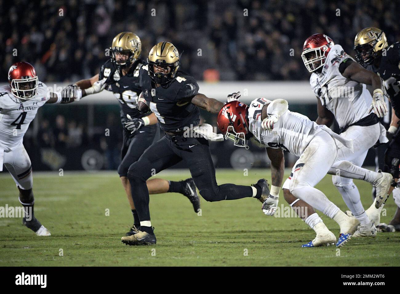 Central Florida running back Taj McGowan (4) rushes for yardage between ...