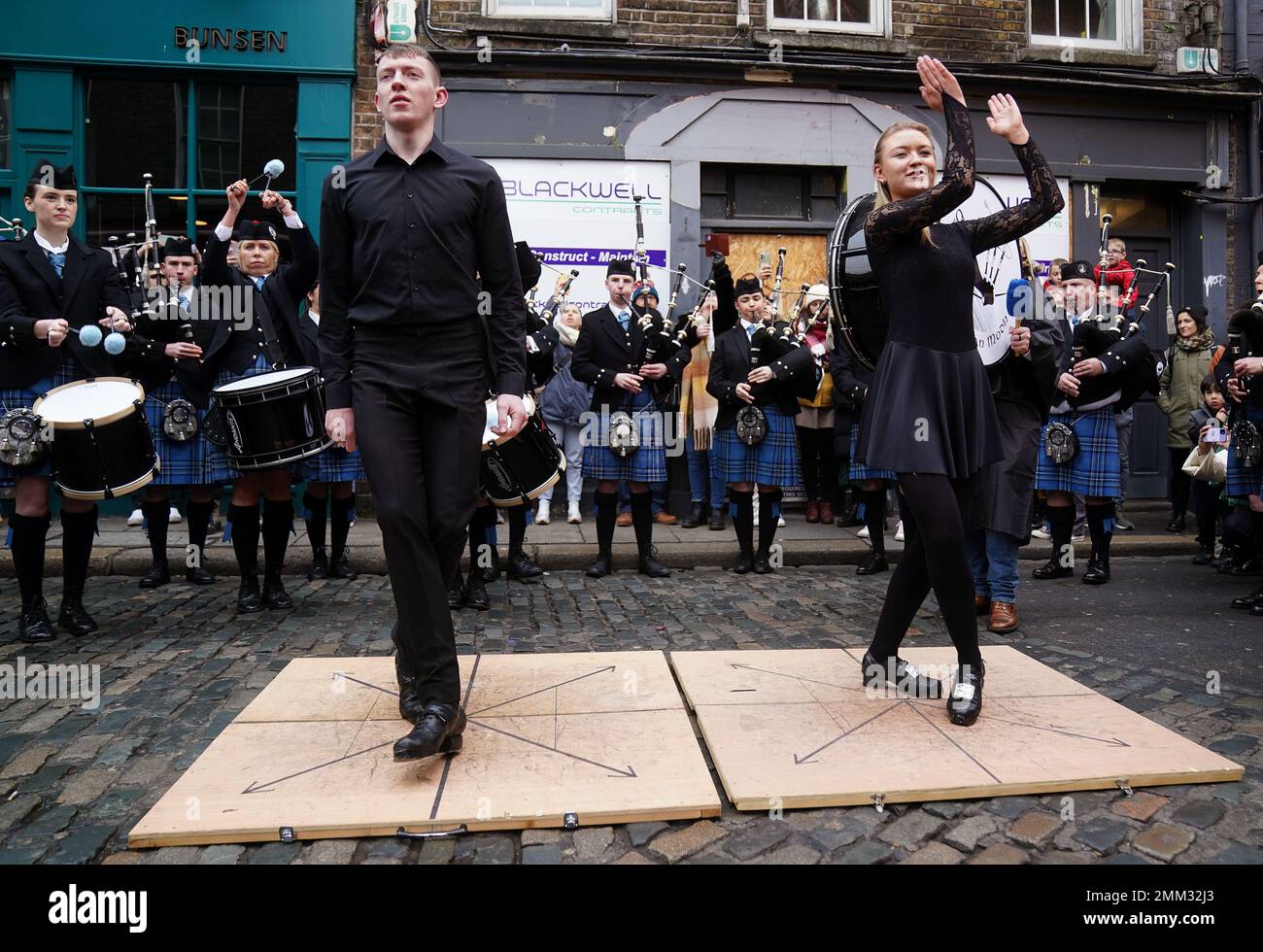 Dancers join the Clew Bay Pipe Band during a performance on the streets ...