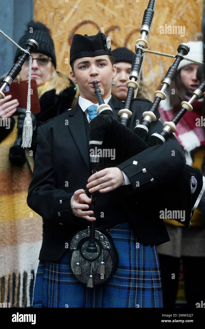 A member of the Clew Bay Pipe Band as they march through the streets of ...