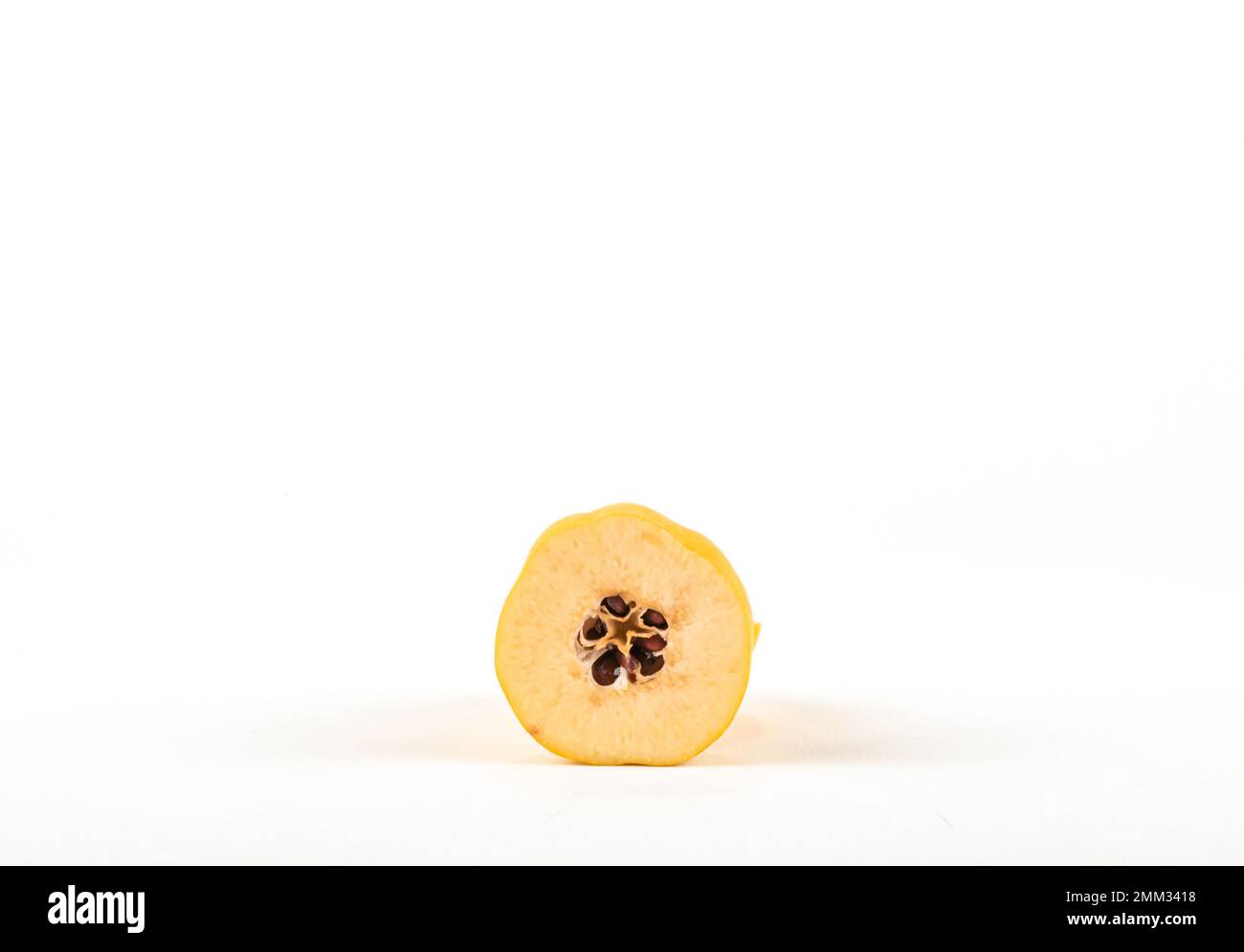 Half of quince with seeds appear on white background. Quince seeds with ...
