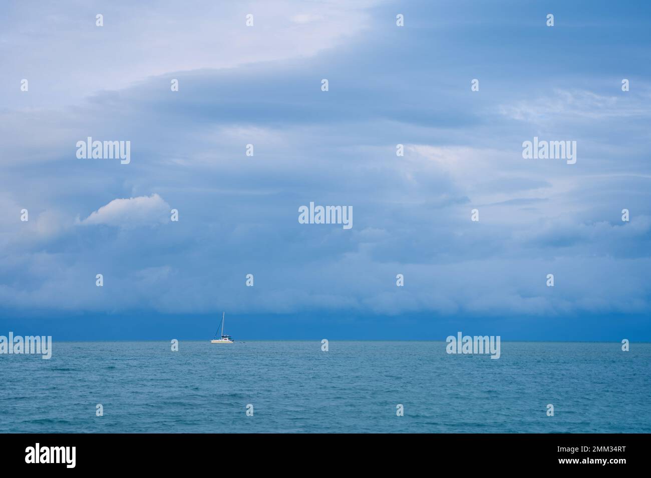 Rain clouds over an island in the sea. The rain is coming Stock Photo ...