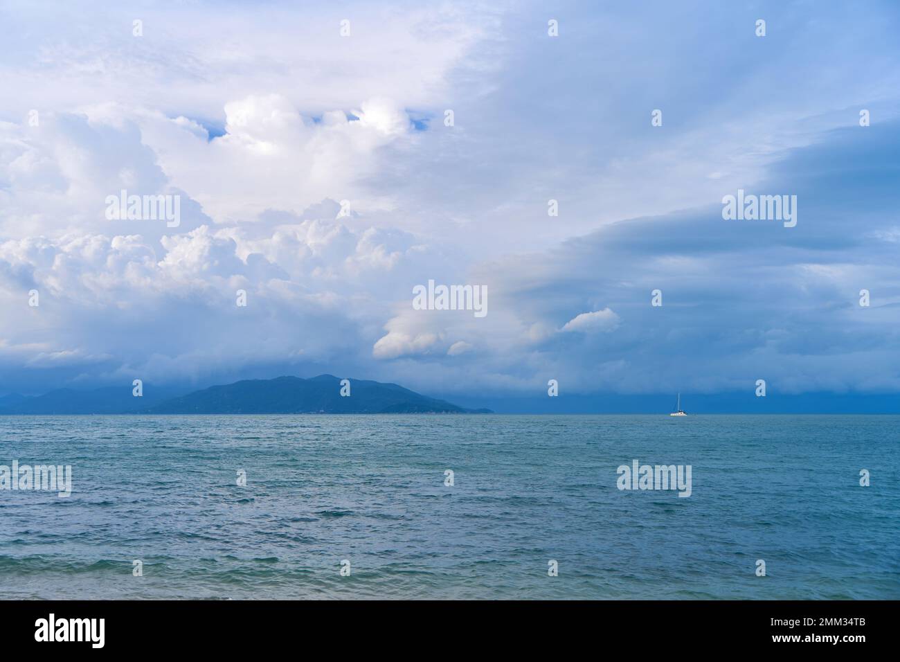 Rain clouds over an island in the sea. The rain is coming Stock Photo ...