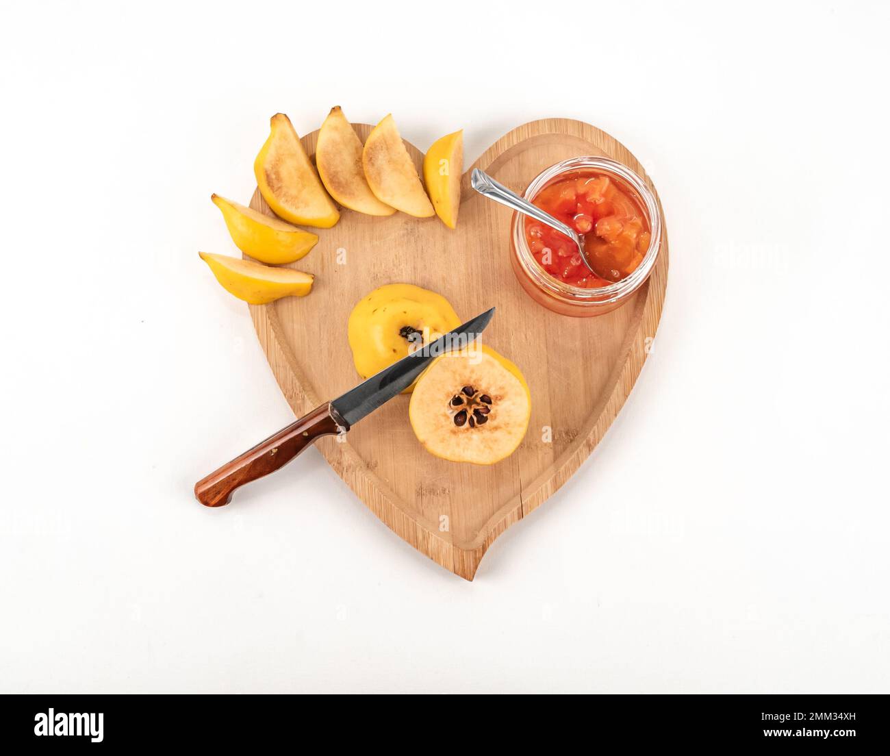Top view spoon and knife cutting Fresh ripe quince and jam on white ...